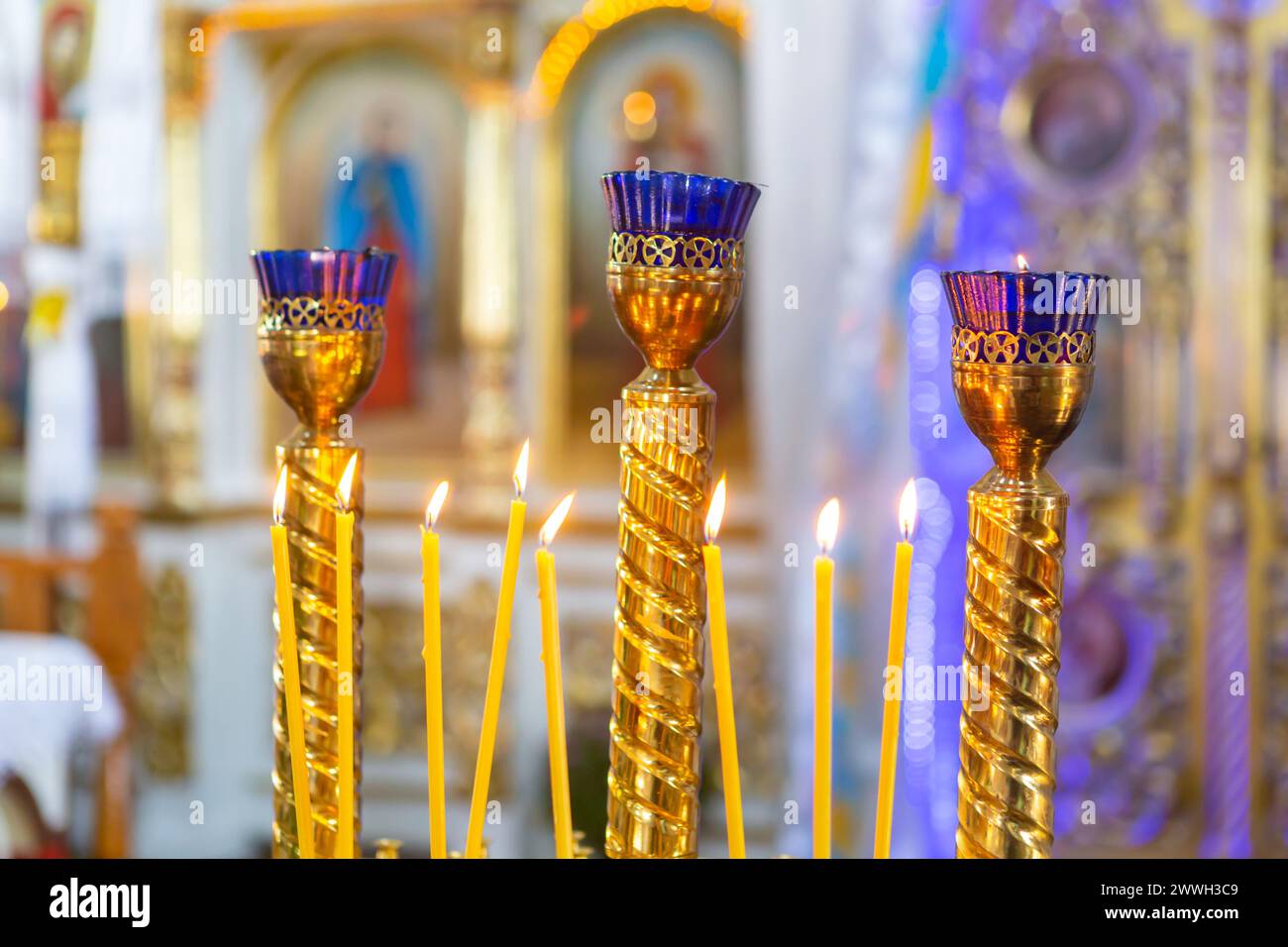 Burning wax candles in a Buddhist temple close-up. Rituals of worship ...