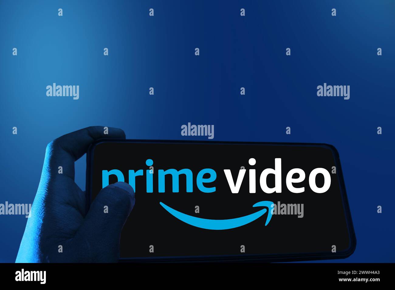Boy holding smart phone with Prime Video streaming app on screen. The ...