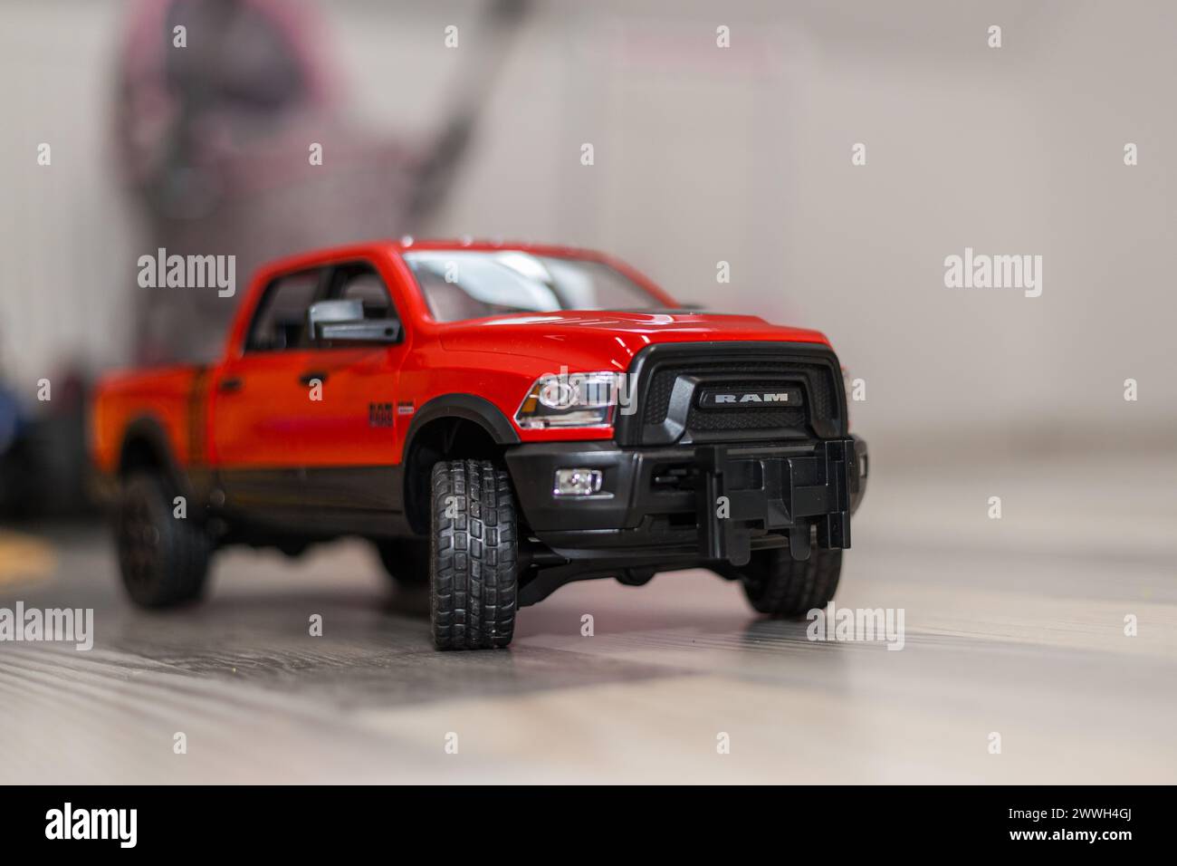 A toy miniature model of a Dodge Ram. The car is red in colour and made ...