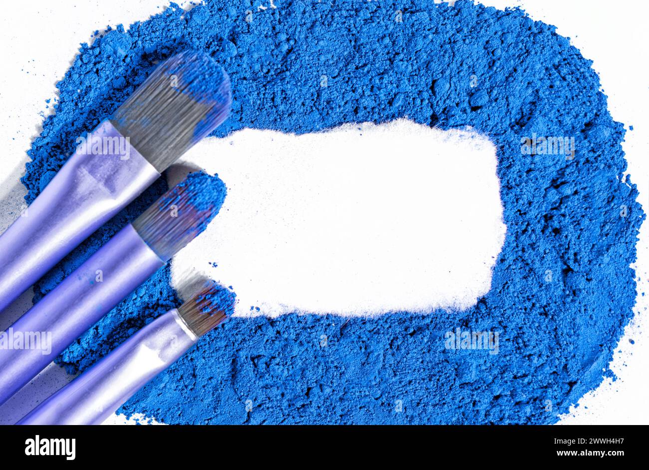 cosmetic brushes on blue dry dye, place for text Stock Photo - Alamy