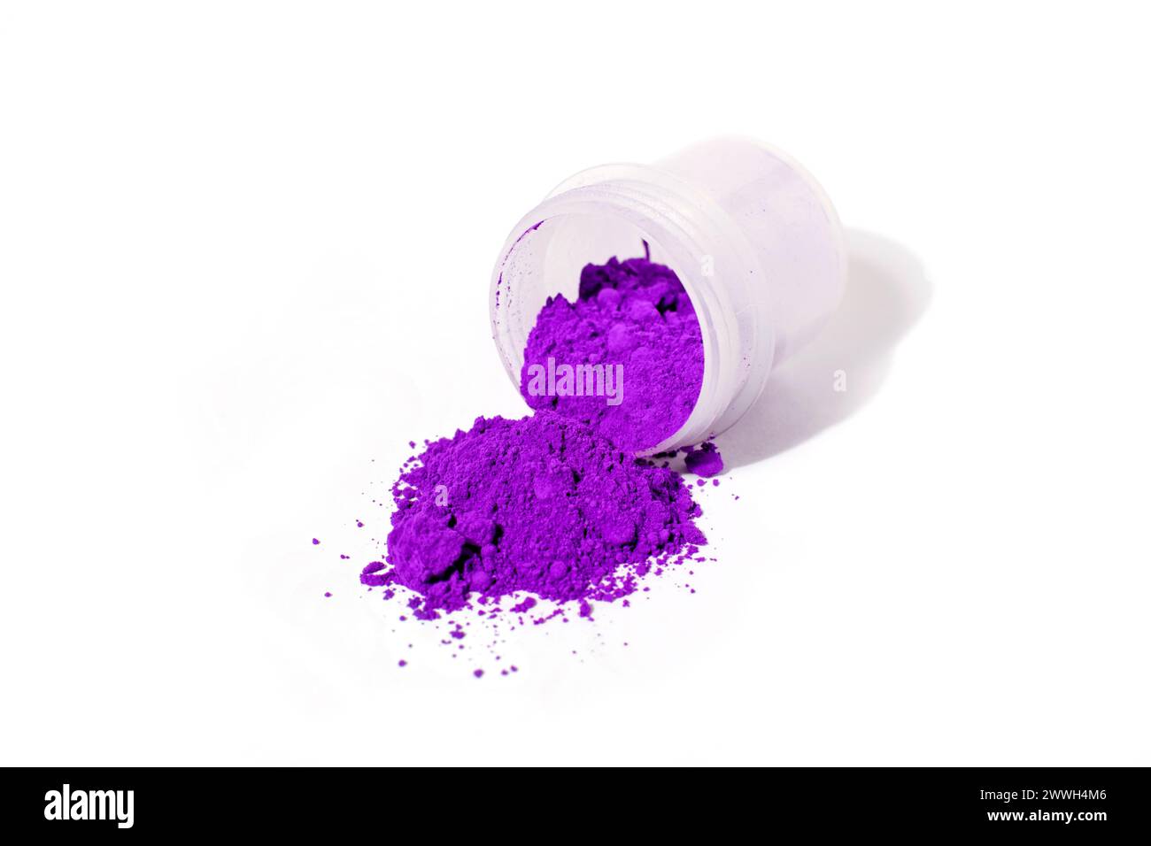 a bunch of dry natural purple pigment on a white background macro ...