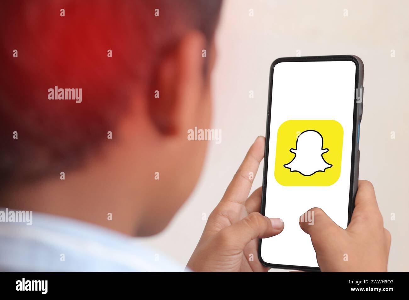 Closeup of a hand, This photo illustration displays the snapchat logo ...