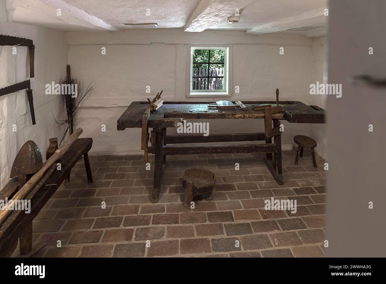 Workroom with workbench and tools in a historic farmhouse from the 19th ...