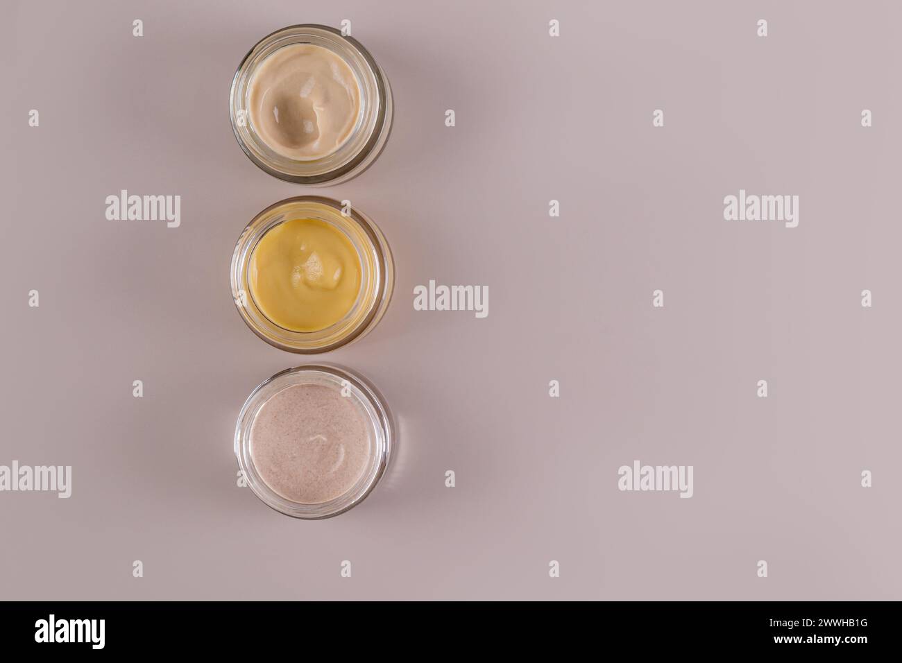 A jars with cosmetic cream of different textures and colors for face ...