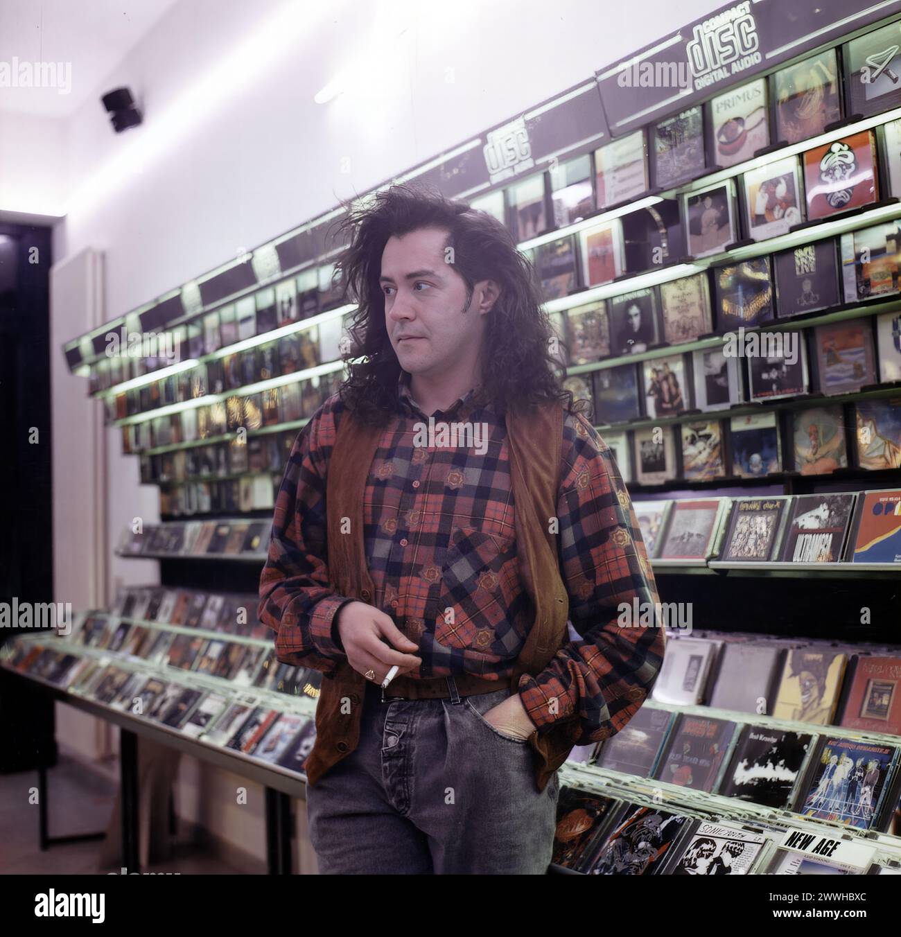 Boy from the 90s inside a compact disc store, holding a cigarette Stock ...