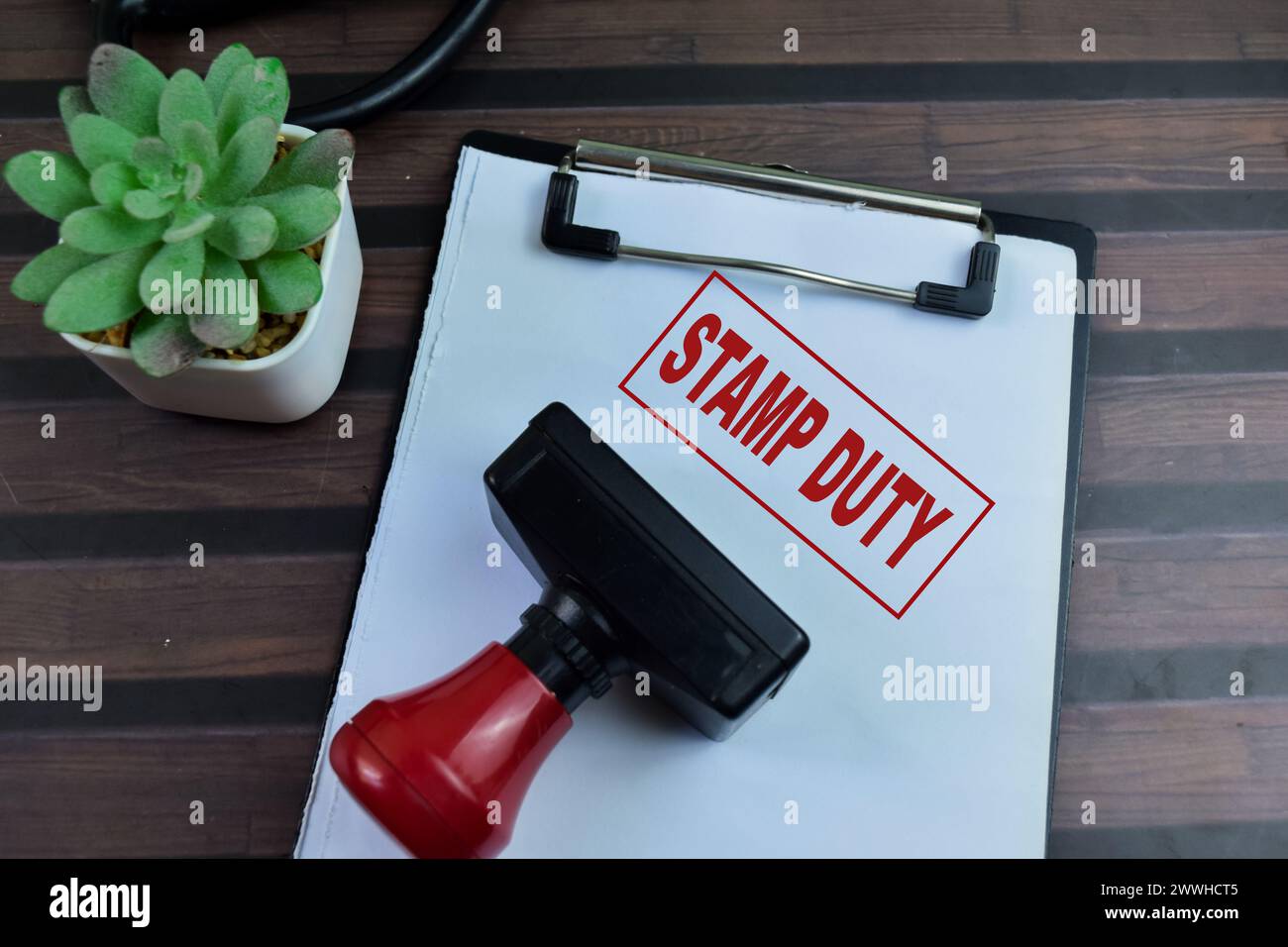 Red Handle Rubber Stamper and Stamp Duty text above paperwork isolated ...