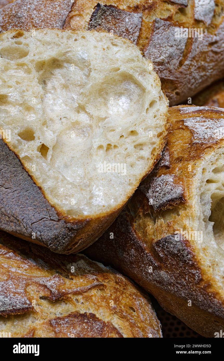 Group of large loaves of freshly baked traditional wheat bread ...