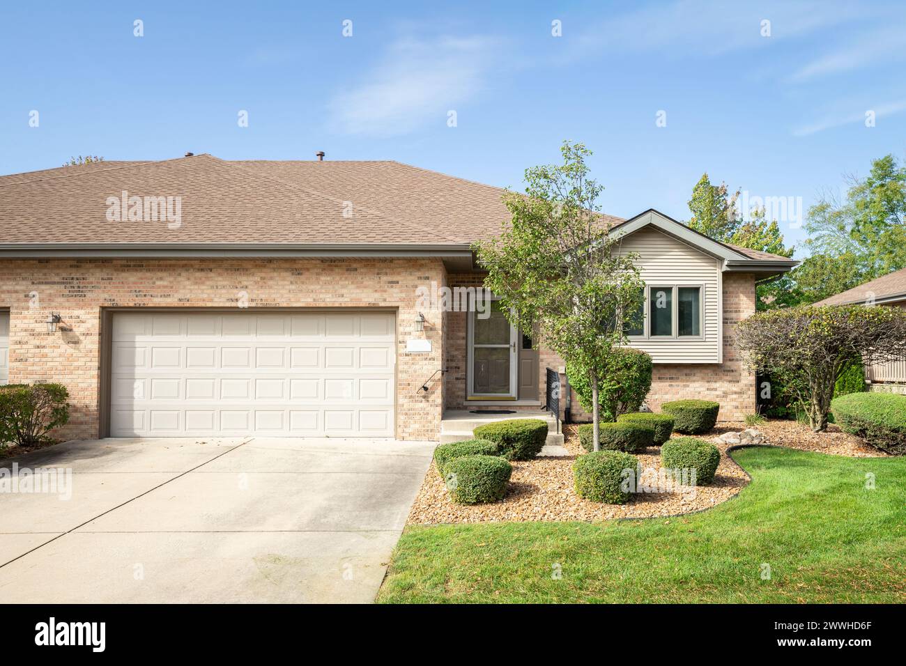 A ranch duplex home brick and vinyl siding, a two car garage and ...