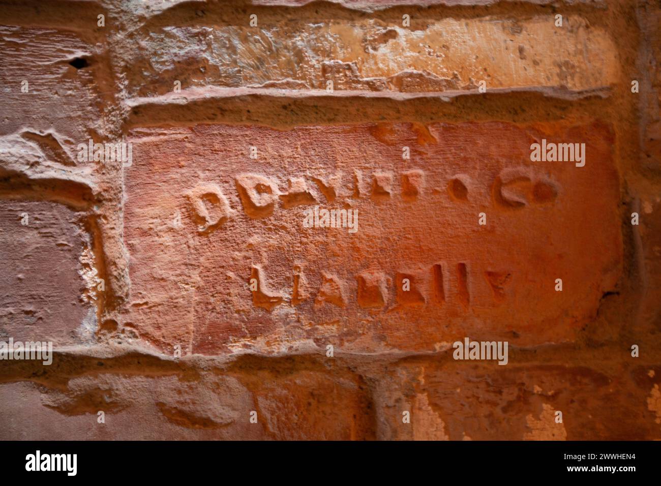 Red brick wall, branded bricks, moulded Stock Photo - Alamy