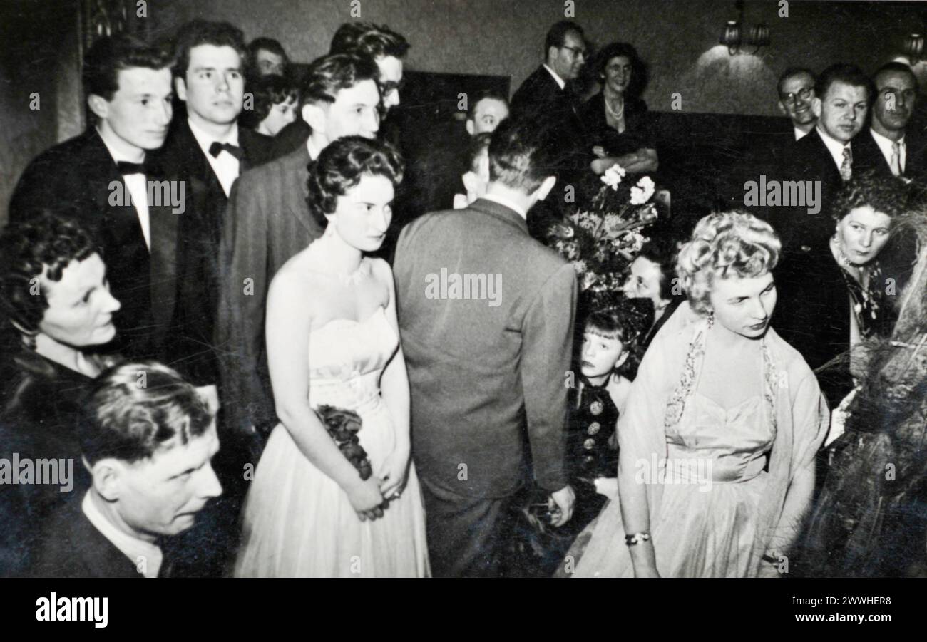 elegant young men and women at a social event in the 1950s or early ...
