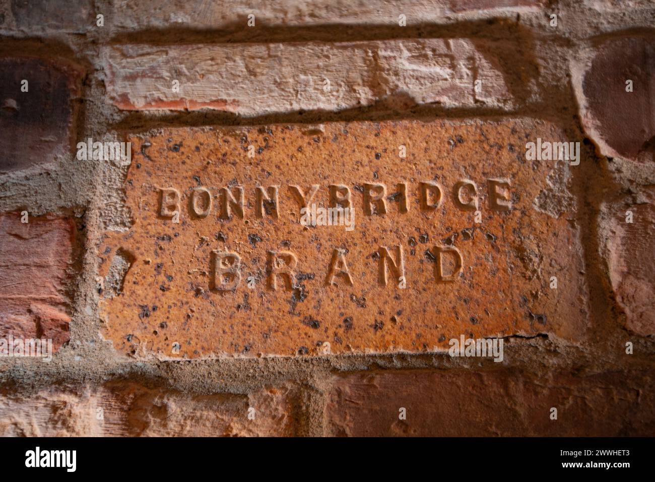 Red brick wall, branded bricks, moulded Stock Photo - Alamy