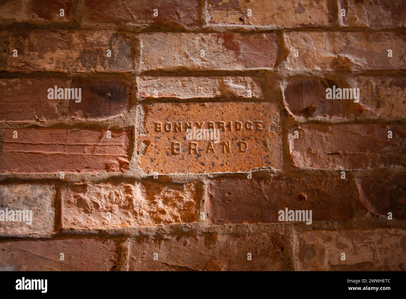 Red brick wall, branded bricks, moulded Stock Photo - Alamy