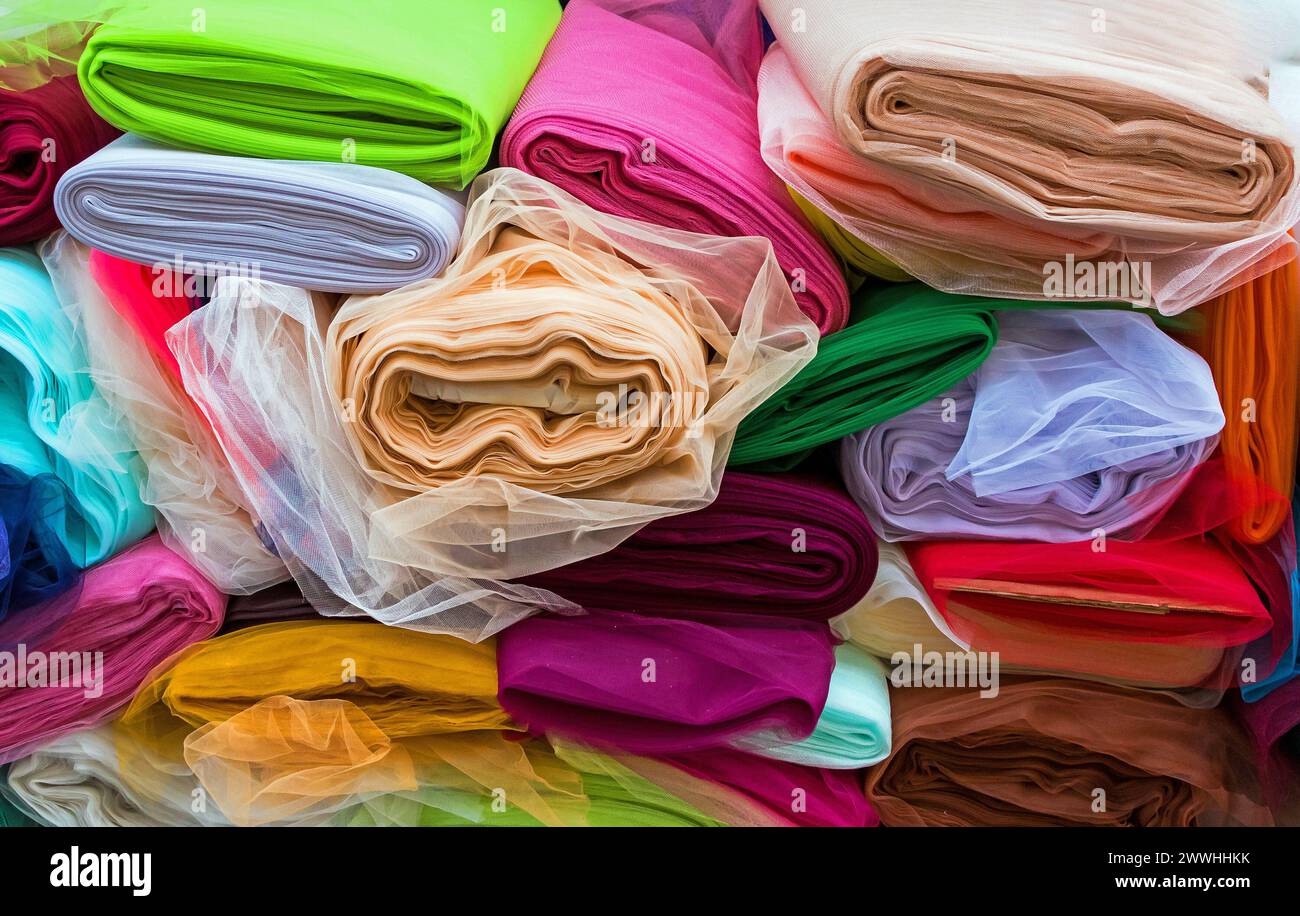 Piles of colorful materials sold outside on street market Stock Photo ...
