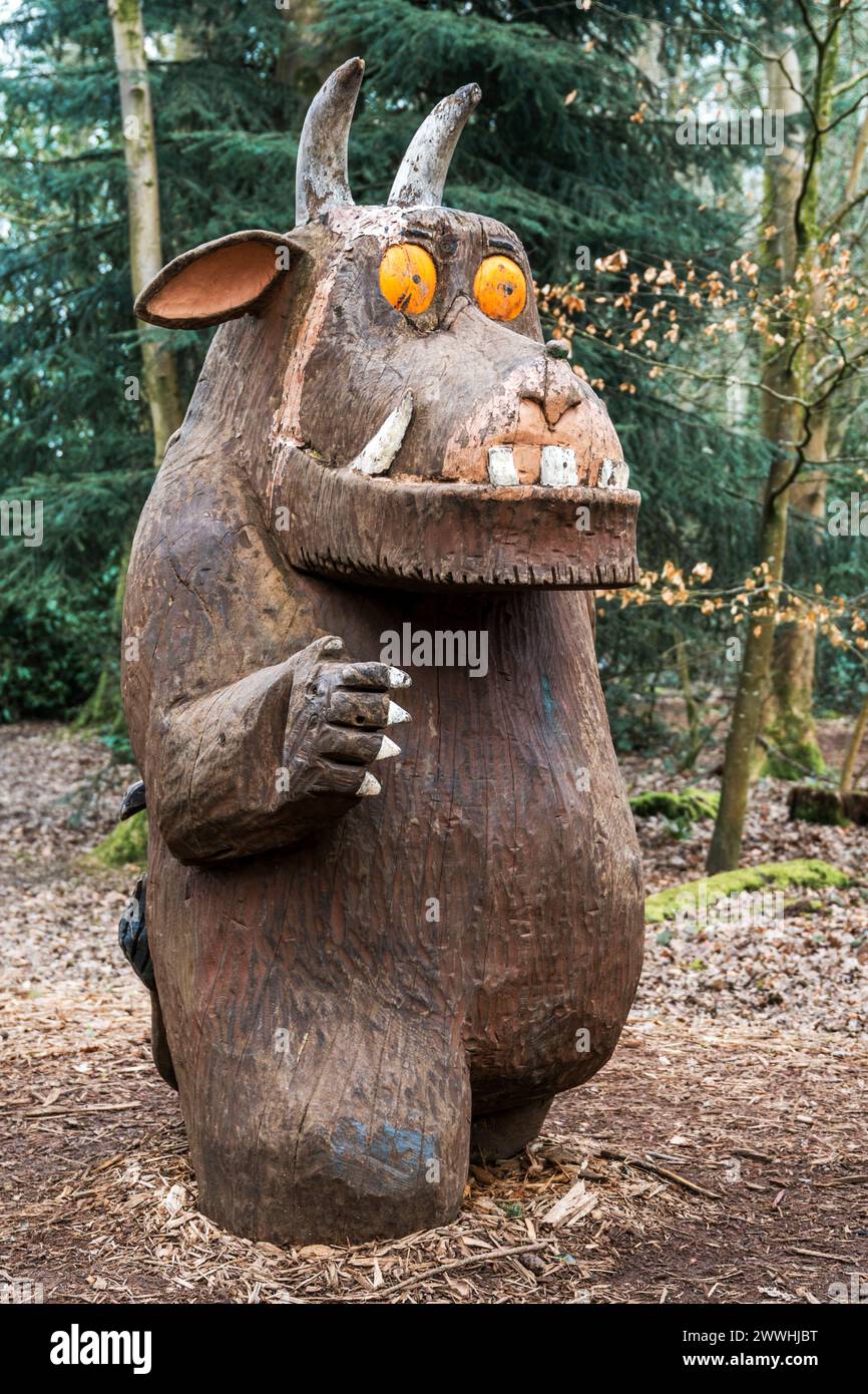 A carved statue of the children's gruffalo character in a woodland ...