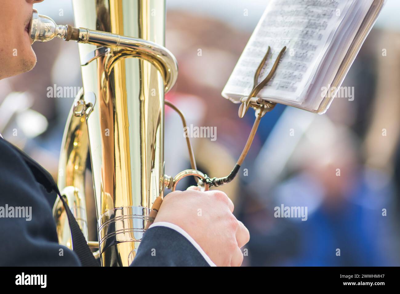Details of hands playing tuba bass during a popular festival in ...