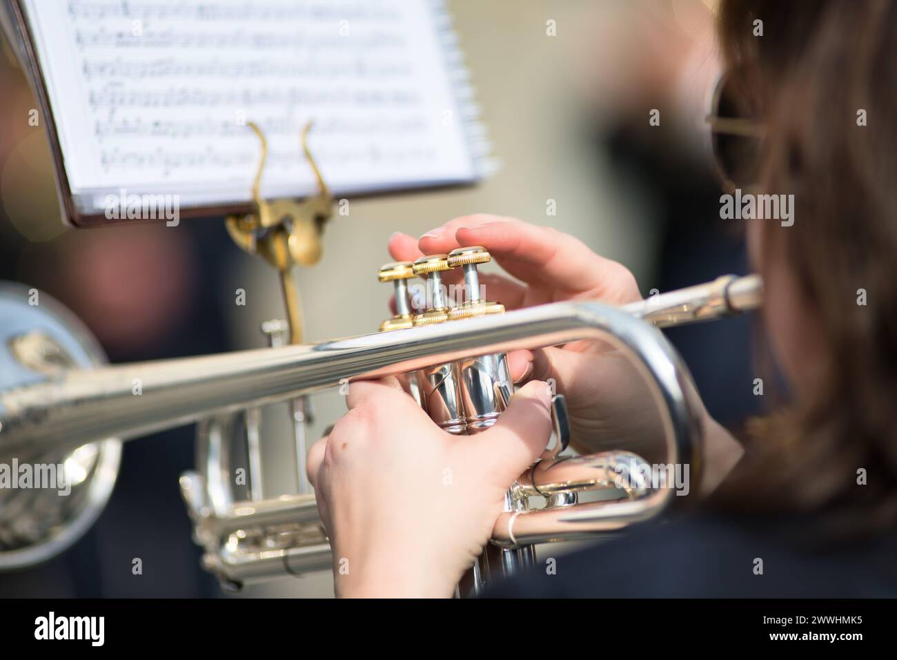 Details of woman's hands playing the trumpet during a popular festival ...