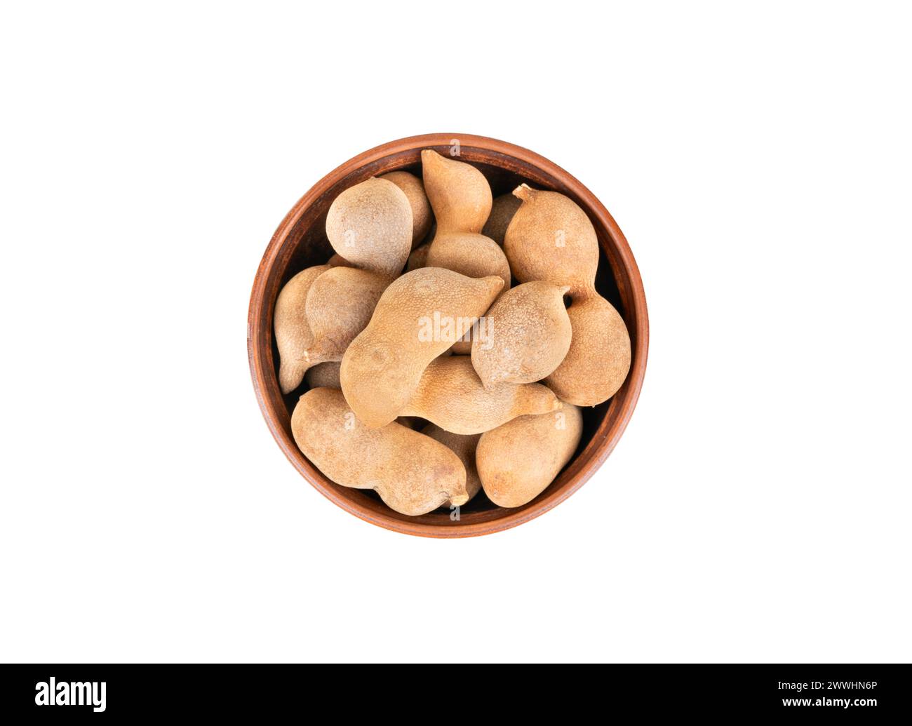 Tamarind fruit in shell and ceramic bowl isolated on white background ...