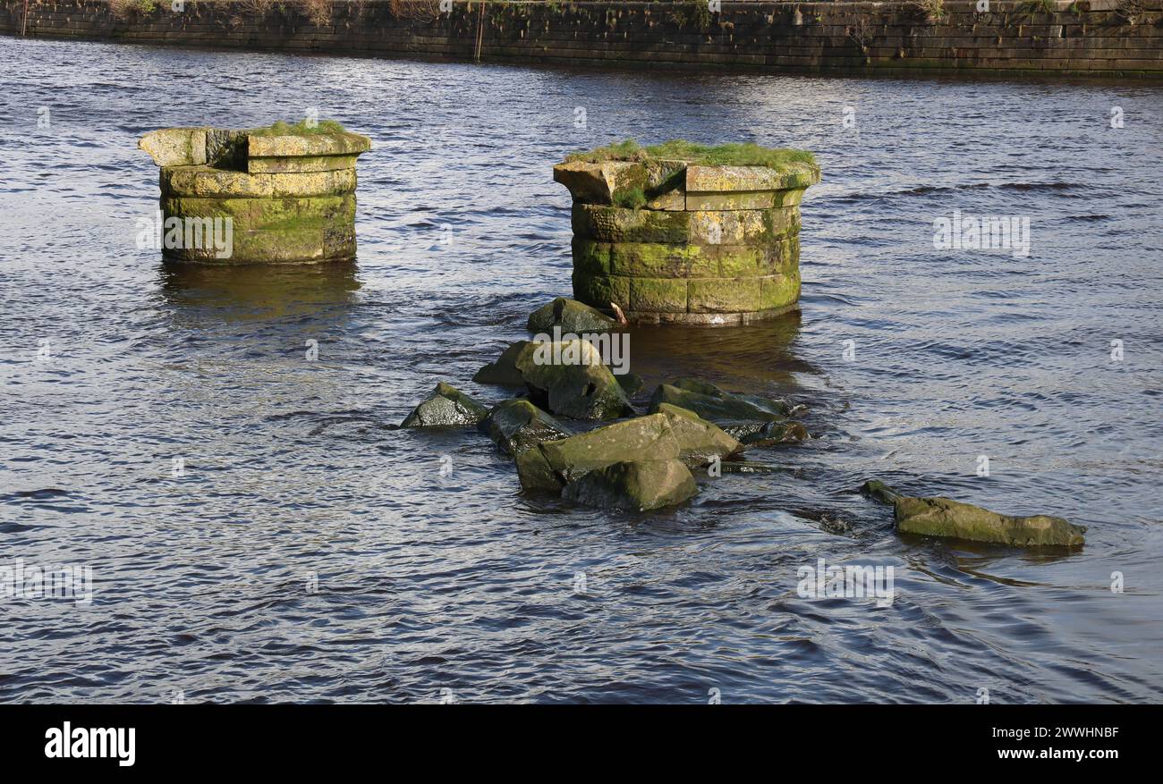 Old derelict stone bridge piers in an urban river estuary Stock Photo ...