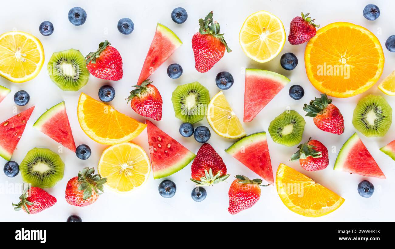 Fresh fruit pieces scattered around on a white background Stock Photo ...