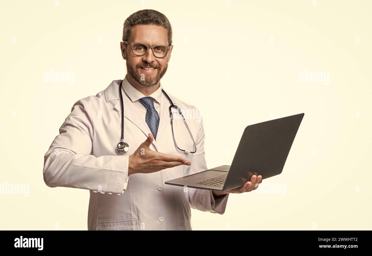 smiling doctor offering emedicine in studio. doctor presenting ...