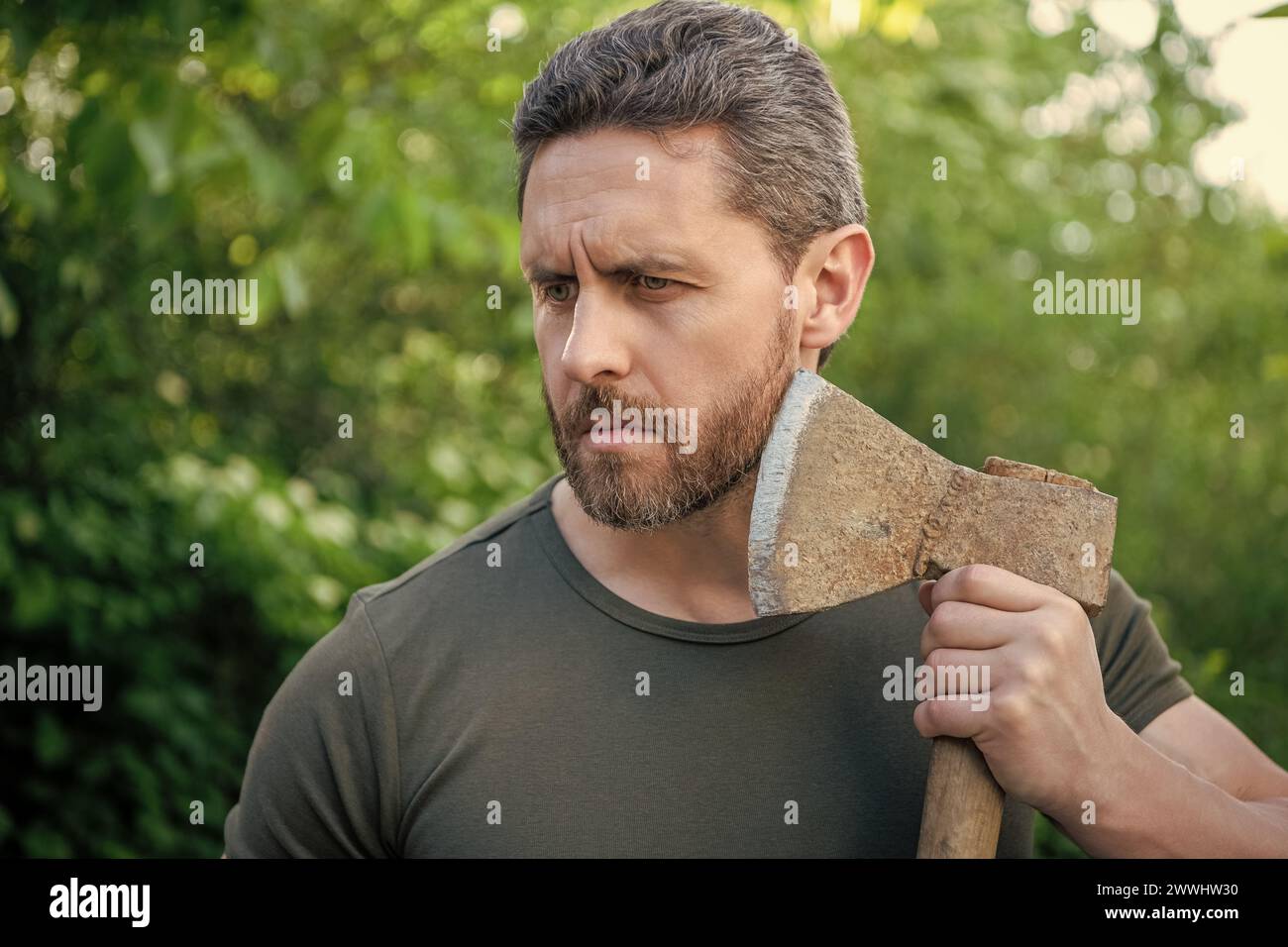 masculine guy holding axe. bearded masculine guy with axe. masculine ...