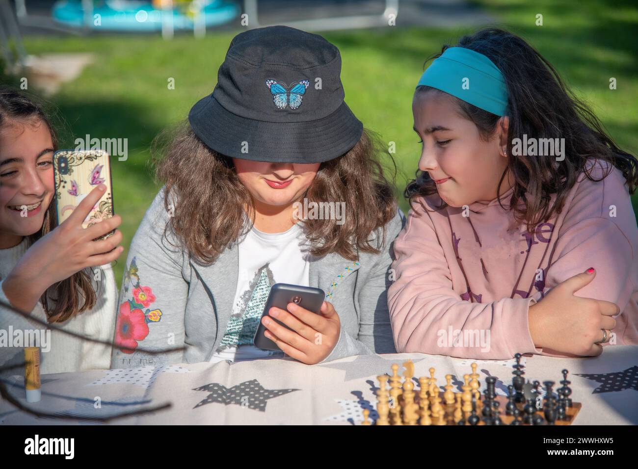 Group of young children playing at table board games Stock Photo - Alamy