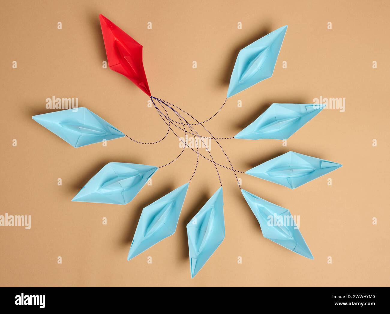 Group of paper boats on a brown background.Concept of a strong leader ...