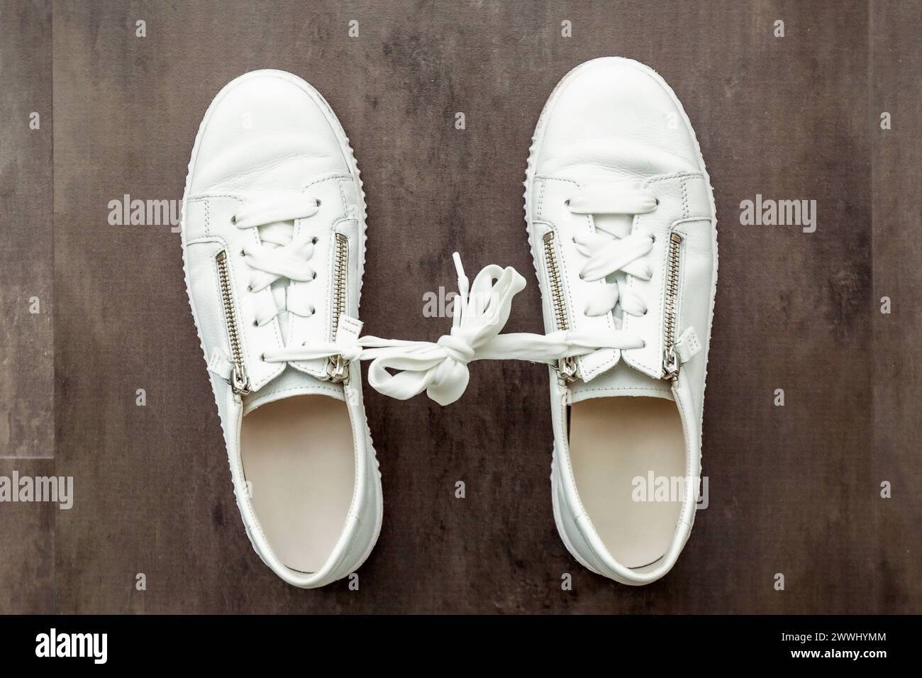 Gamophobia. fear of commitment concept. A pair of white shoes, sneaker ...