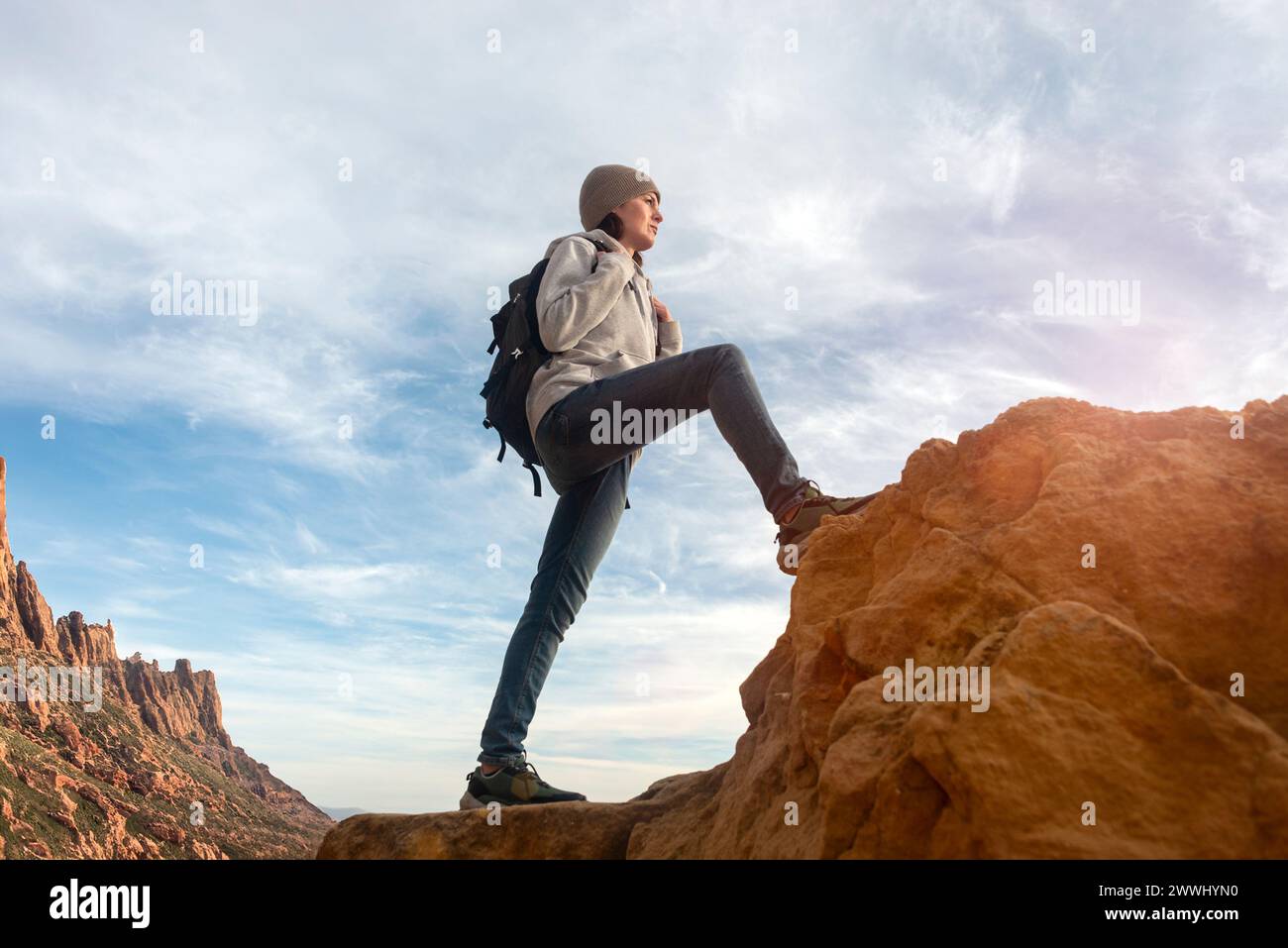 woman hiker with backpack walking up a mountain Stock Photo - Alamy
