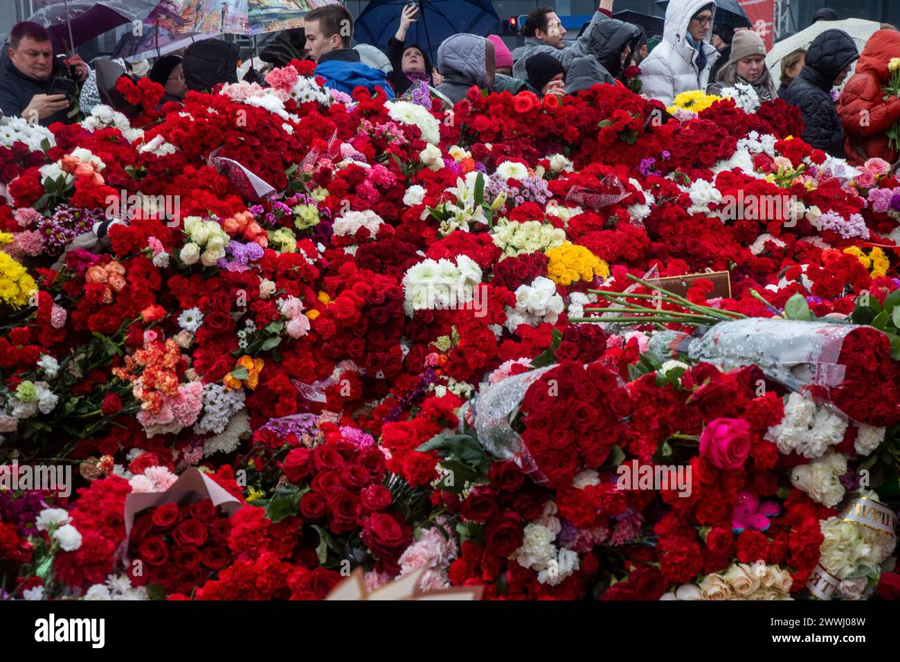 Moscow region, Russia. 24th of March, 2024. People bring flowers to a makeshift memorial outside ...
