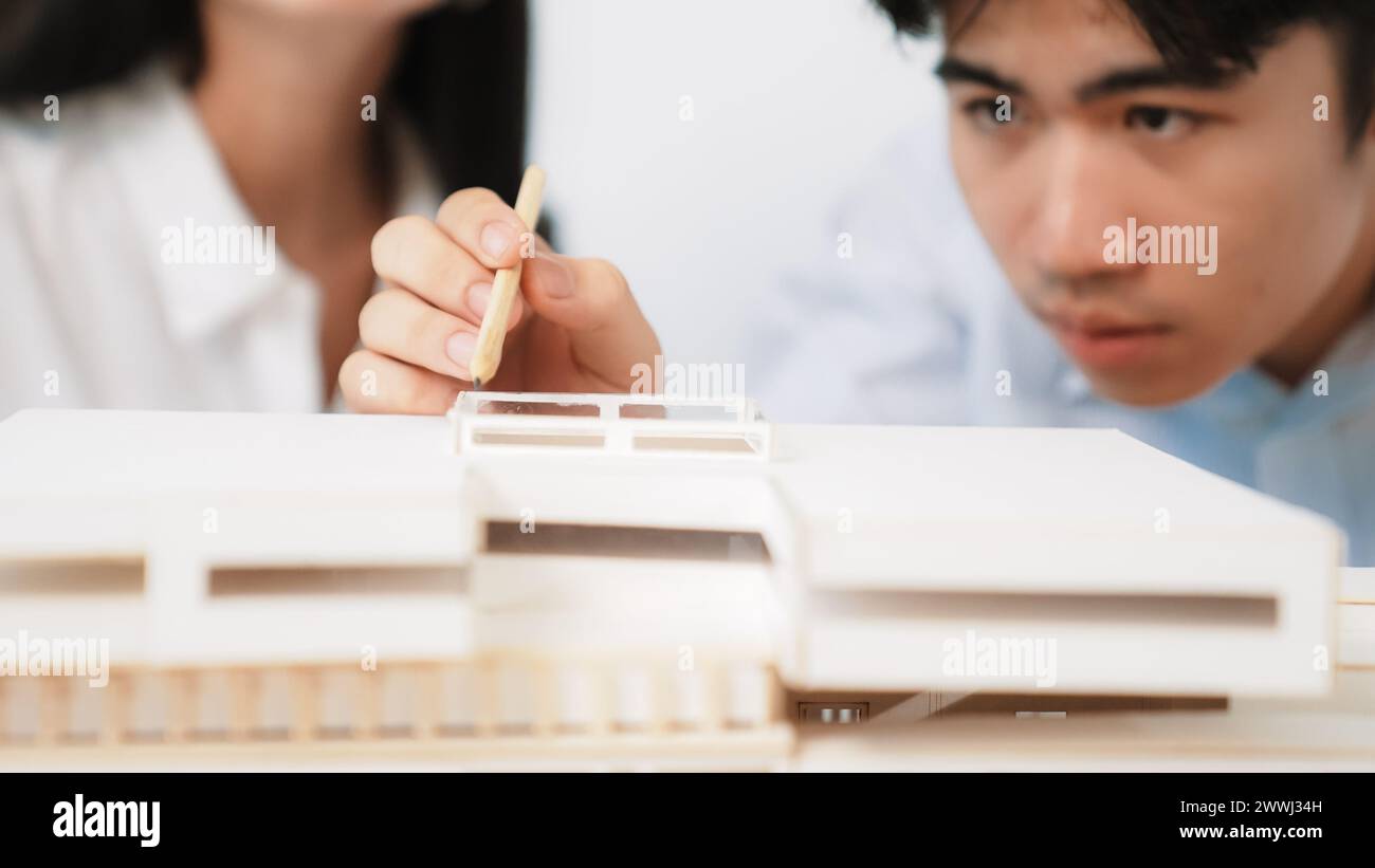 Closeup of young professional architect team work together to use ...