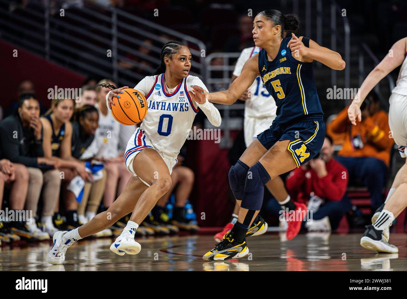 Kansas Jayhawks guard Wyvette Mayberry (0) is defended by Michigan ...