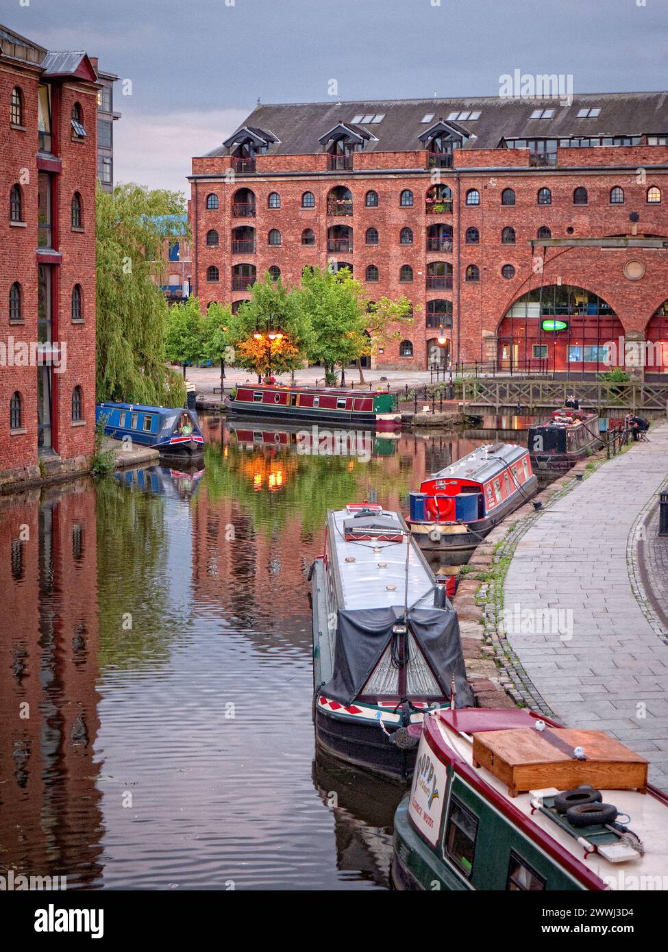 Moored narrowboats in Castlefield Basin among the imposing Victorian ...