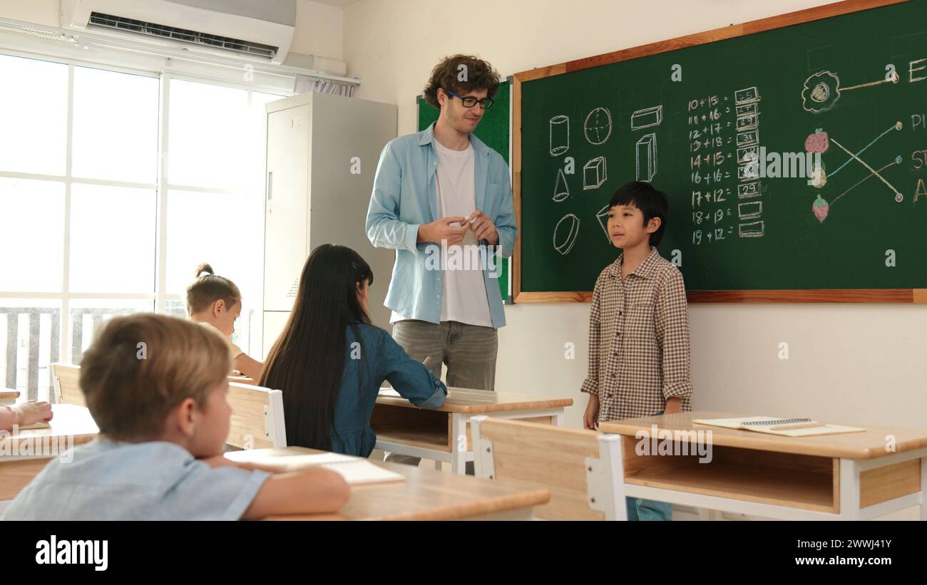 Student standing at in front of class and start to introduce himself at ...