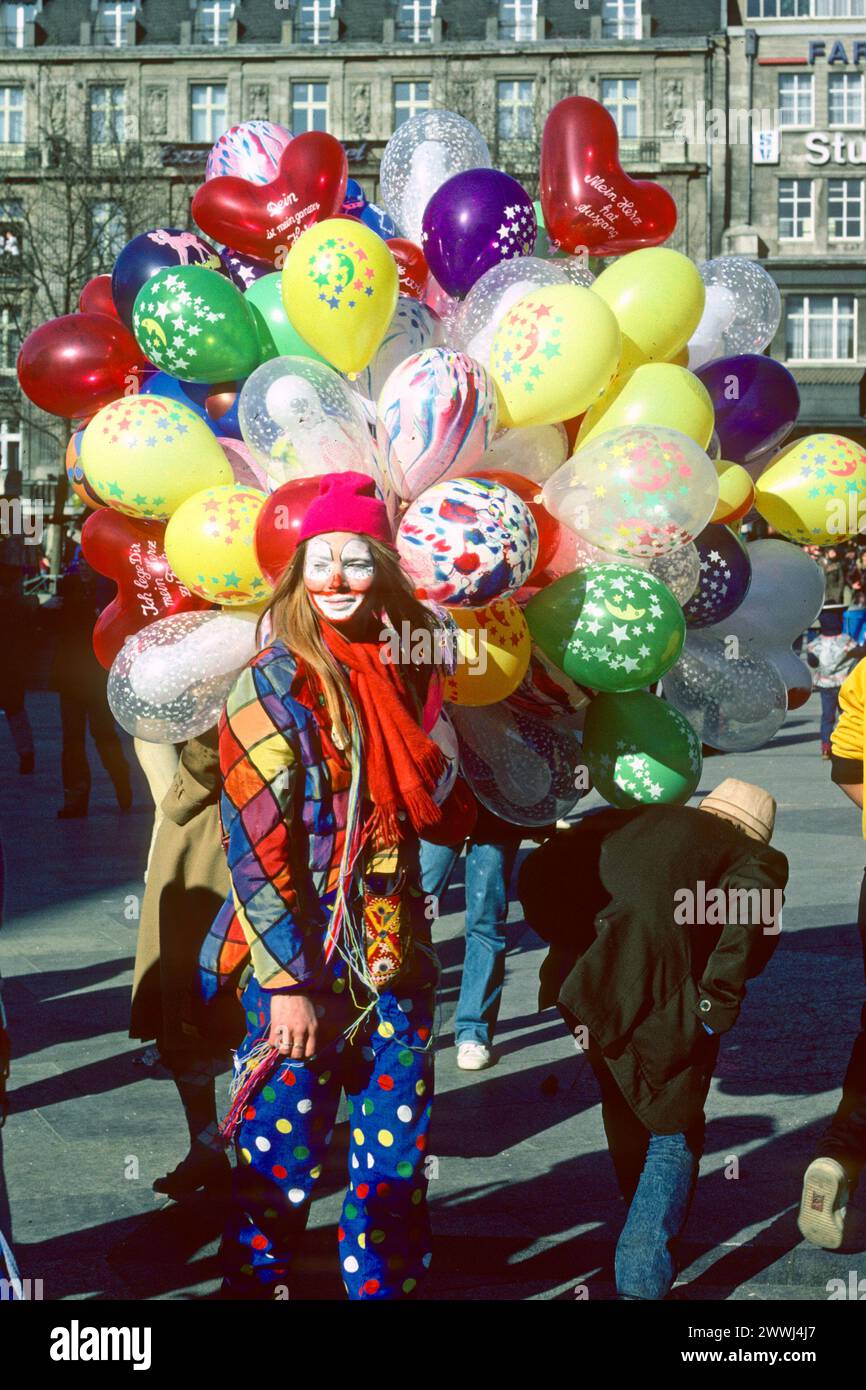 Young woman in clown costume selling balloons at the Carnival parade in ...