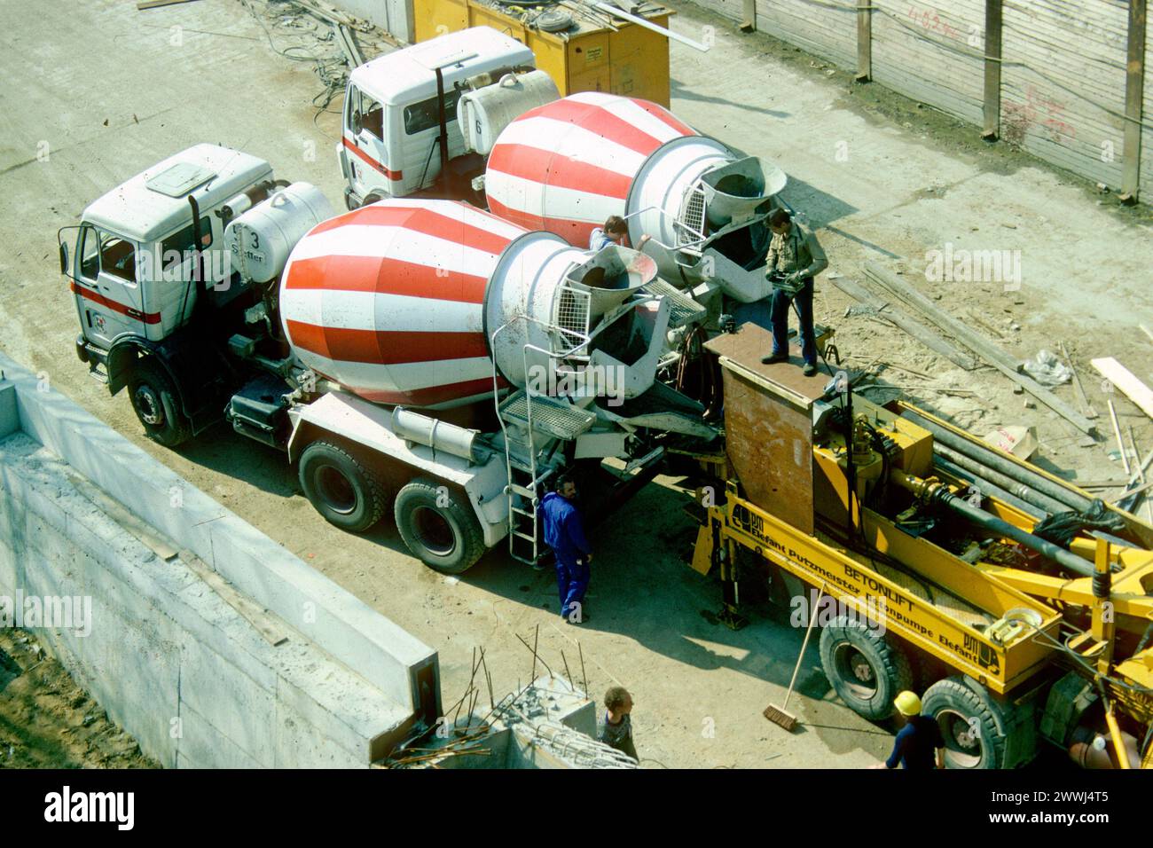 Concrete mixing trucks on site during construction of road tunnel in ...