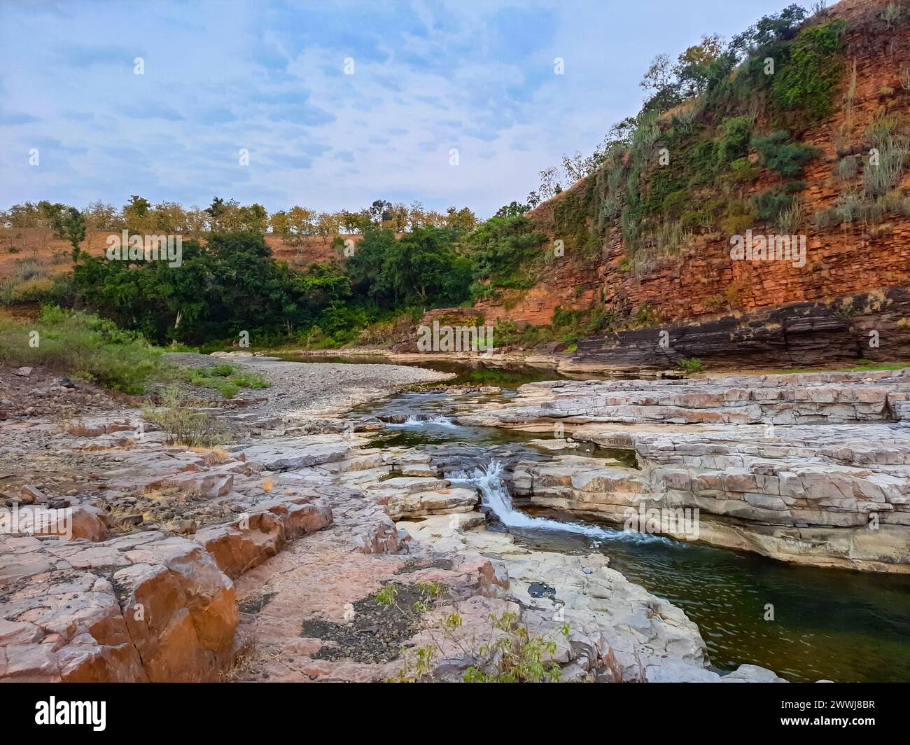 A beautiful waterfall surrounded by rocky mountain at Chidiya Bhadak ...