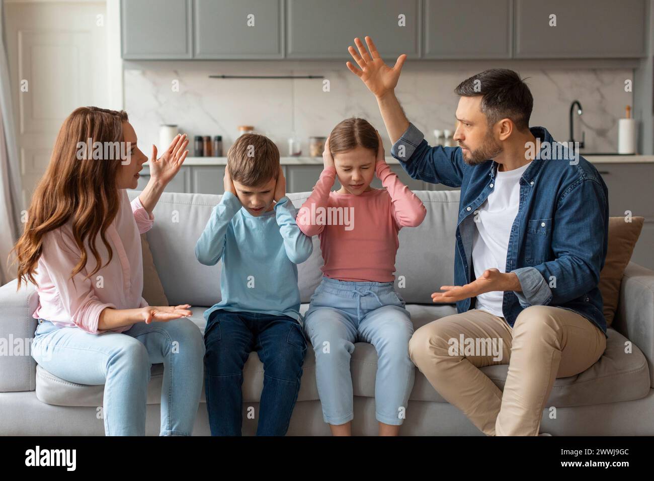 Domestic Quarrels. Man And Woman Arguing In Front Of Kids At Home Stock ...
