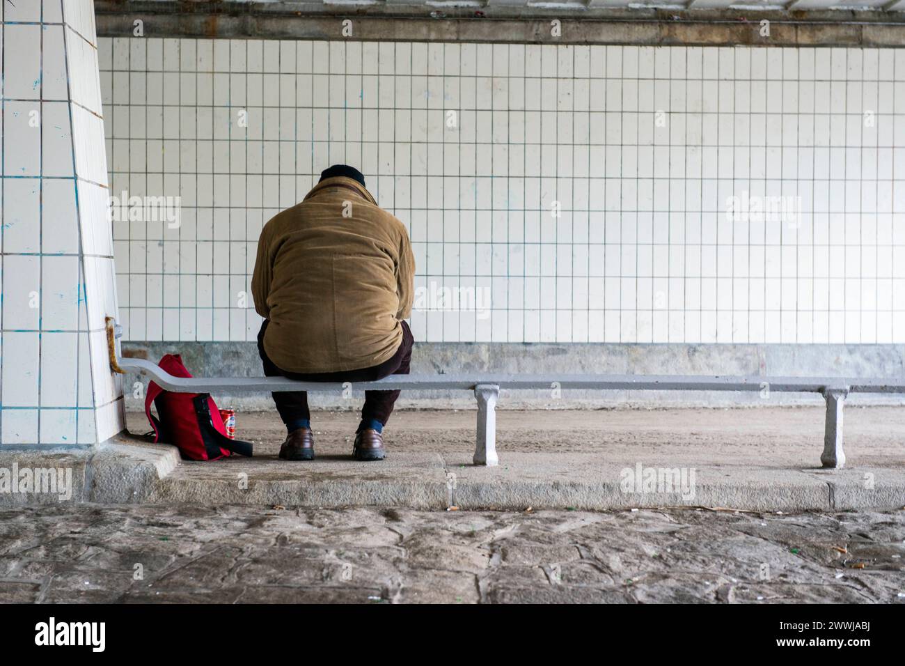 Homeless man sitting under a bridge Amsterdam, Netherlands. Homeles ...