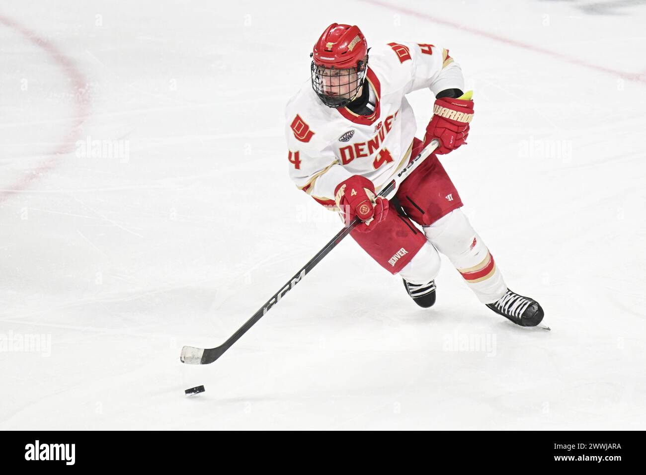 Denver Pioneers forward Jack Devine (4) skates with the puck during the ...