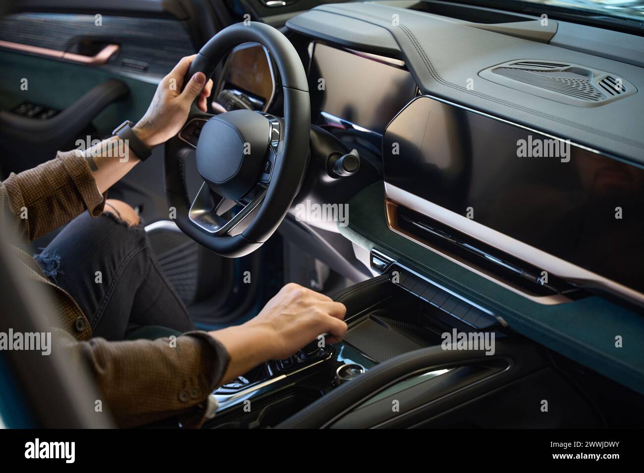Man hands hold the steering wheel of a car Stock Photo - Alamy