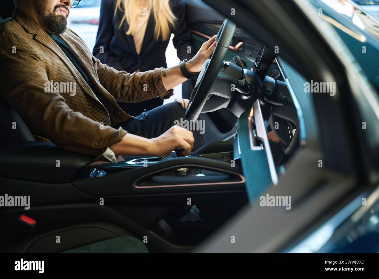 Man sits behind the wheel in a car Stock Photo - Alamy