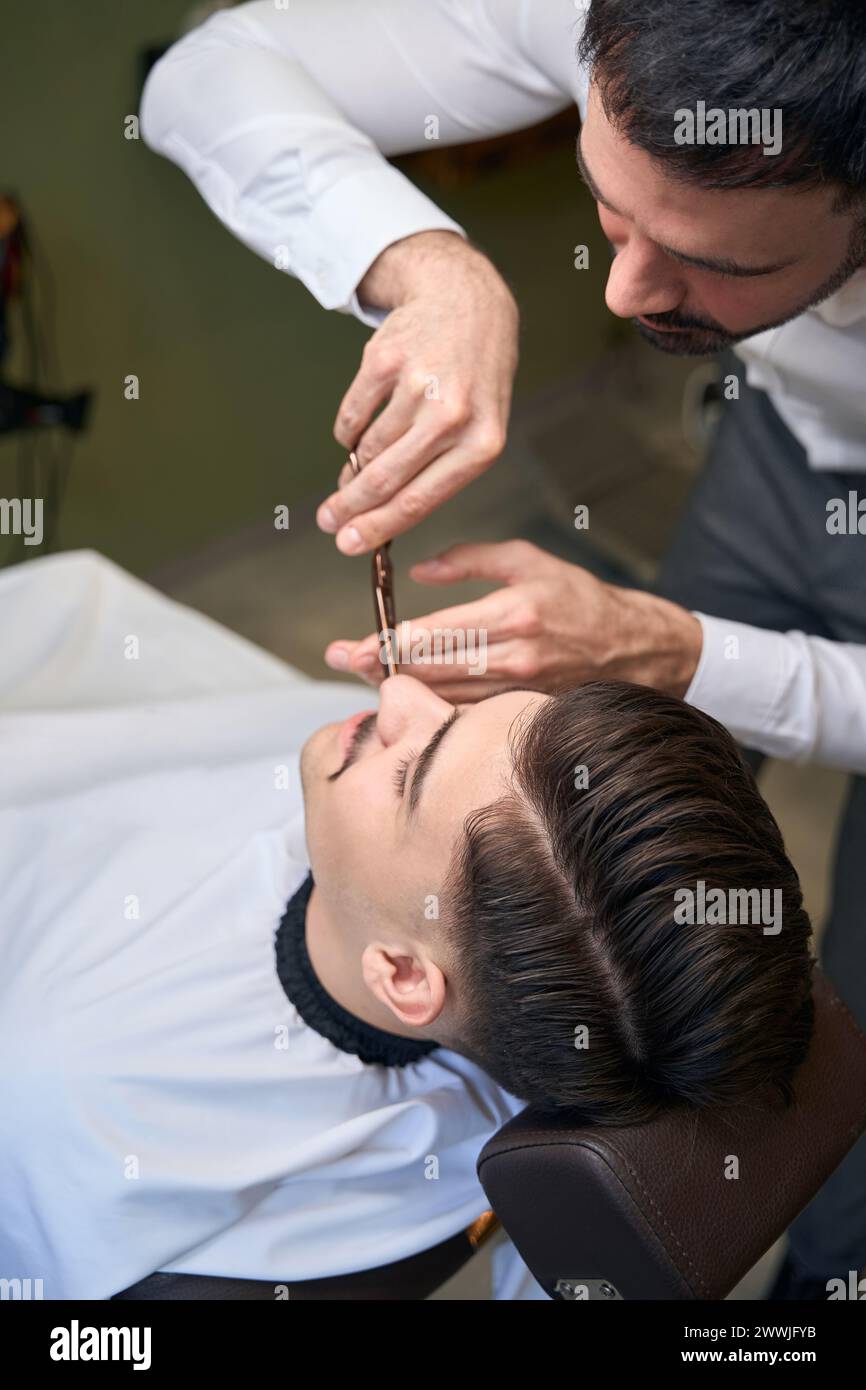 Client visiting barber shop for styling his mustache Stock Photo - Alamy
