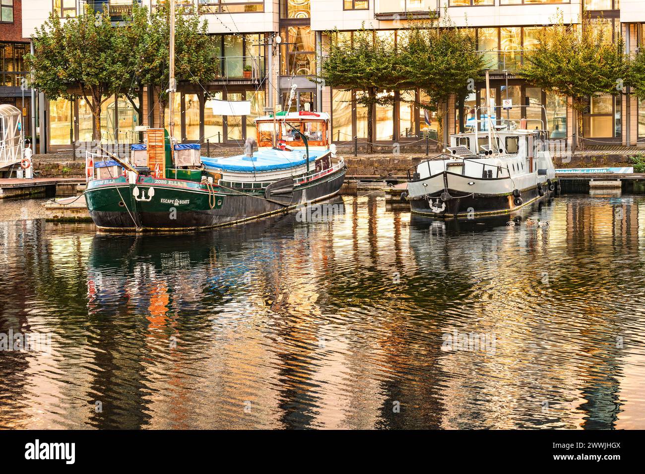 Barges moored in front of a modern building at Grand Canal Dock. Dublin ...
