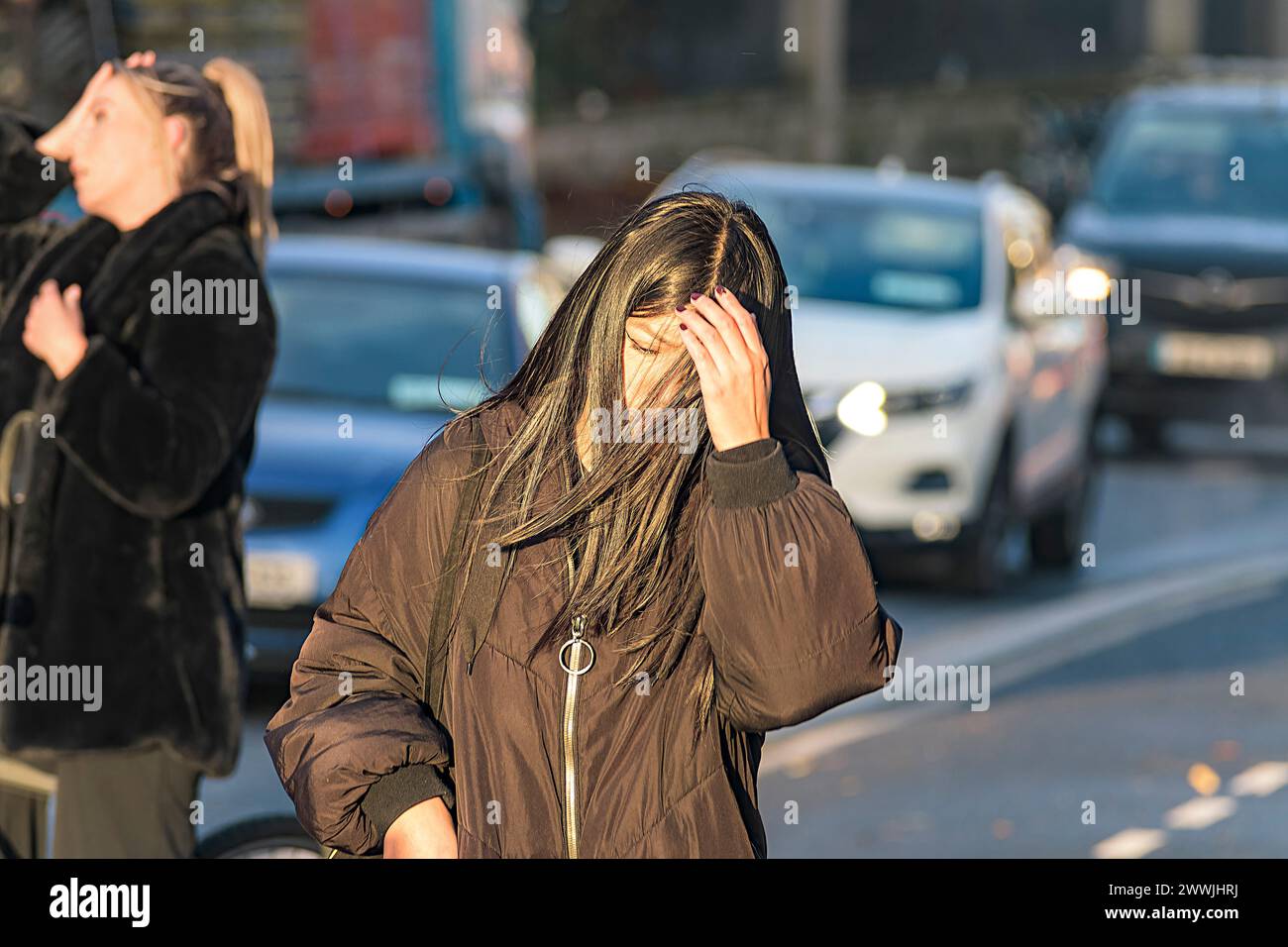 Morning breeze, Dublin beauty. A young woman straightens her hair as ...