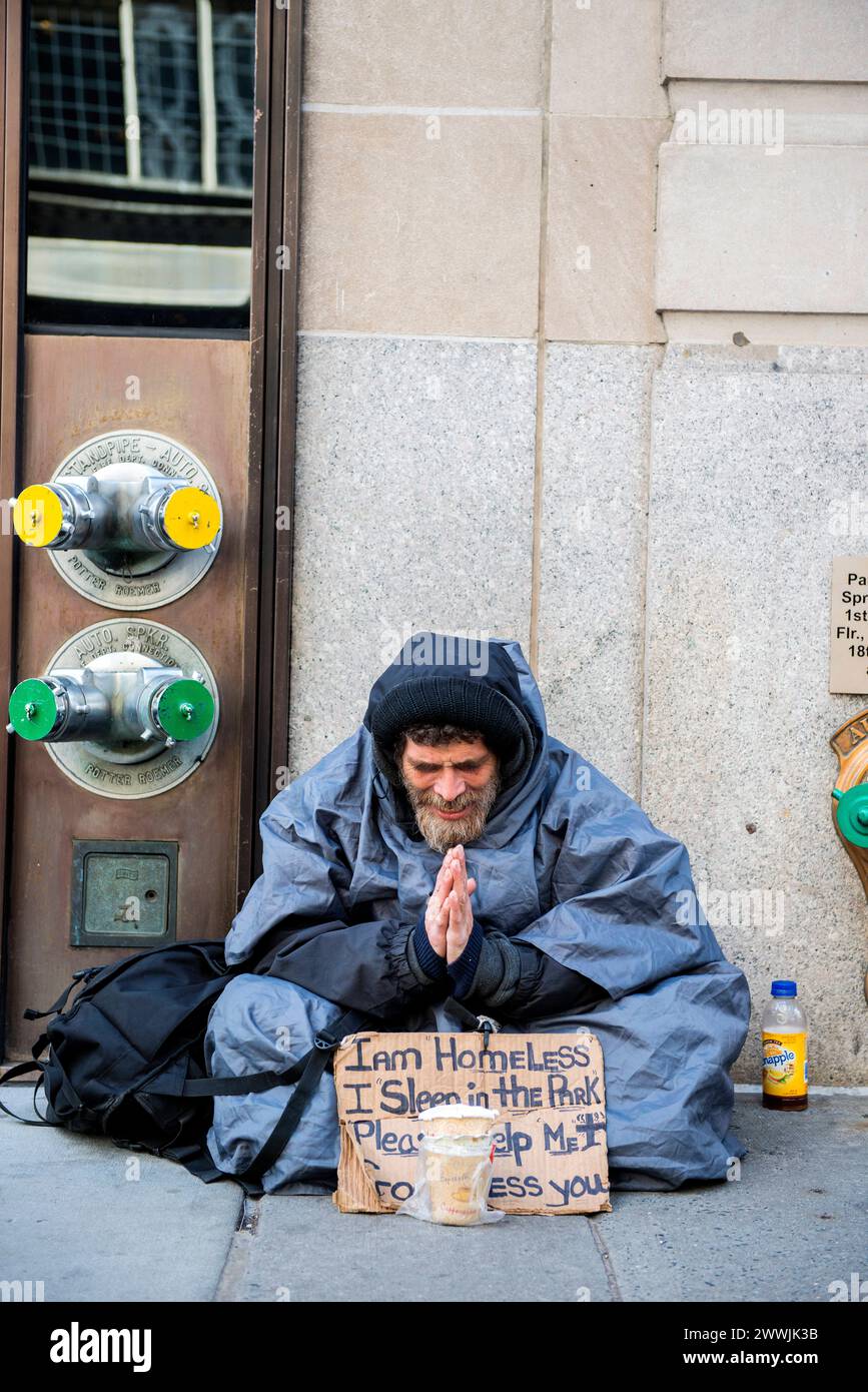 Homeless man praying for a dollar New York City, USA. Homeless man ...
