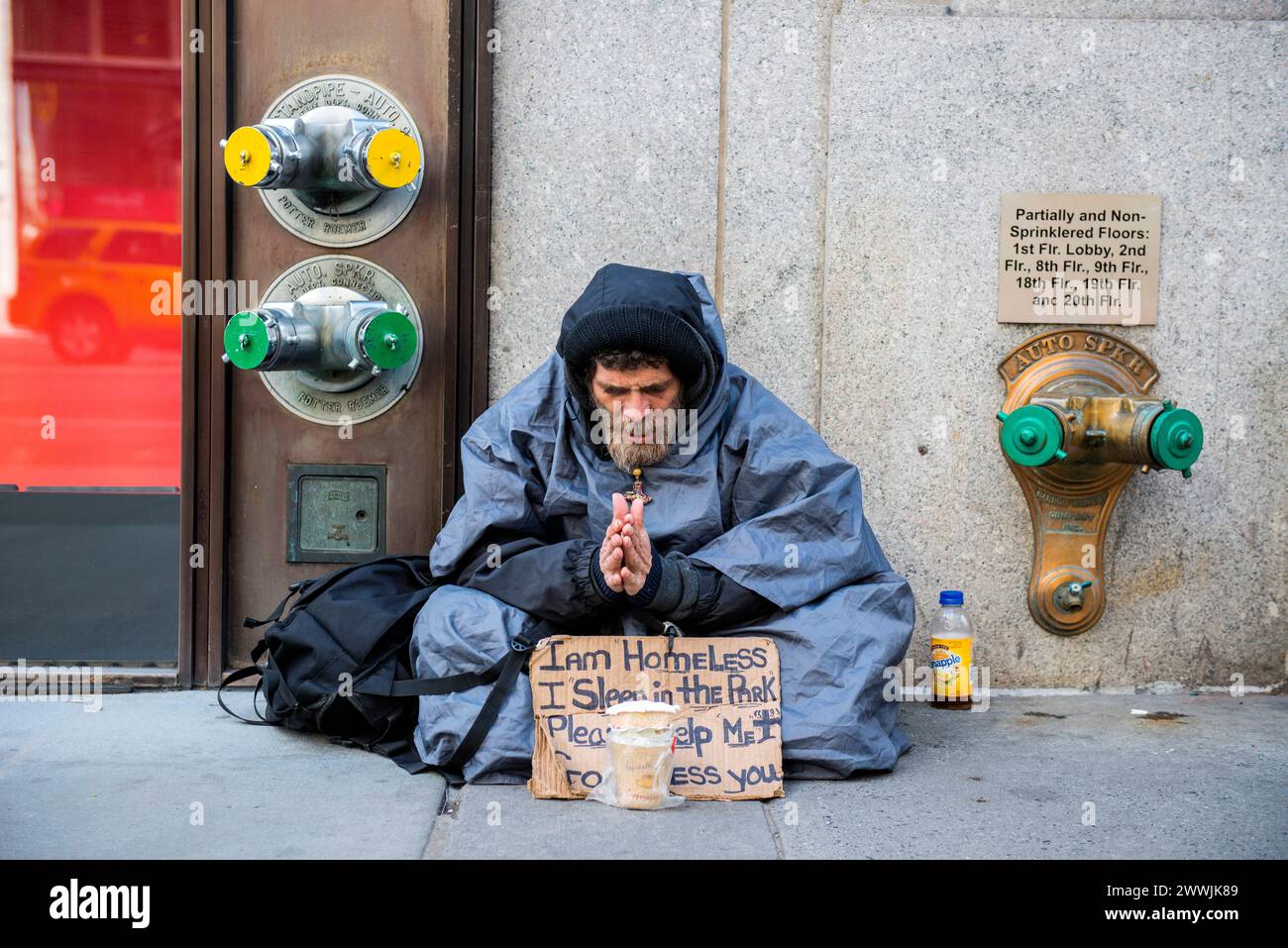 Homeless man praying for a dollar New York City, USA. Homeless man ...