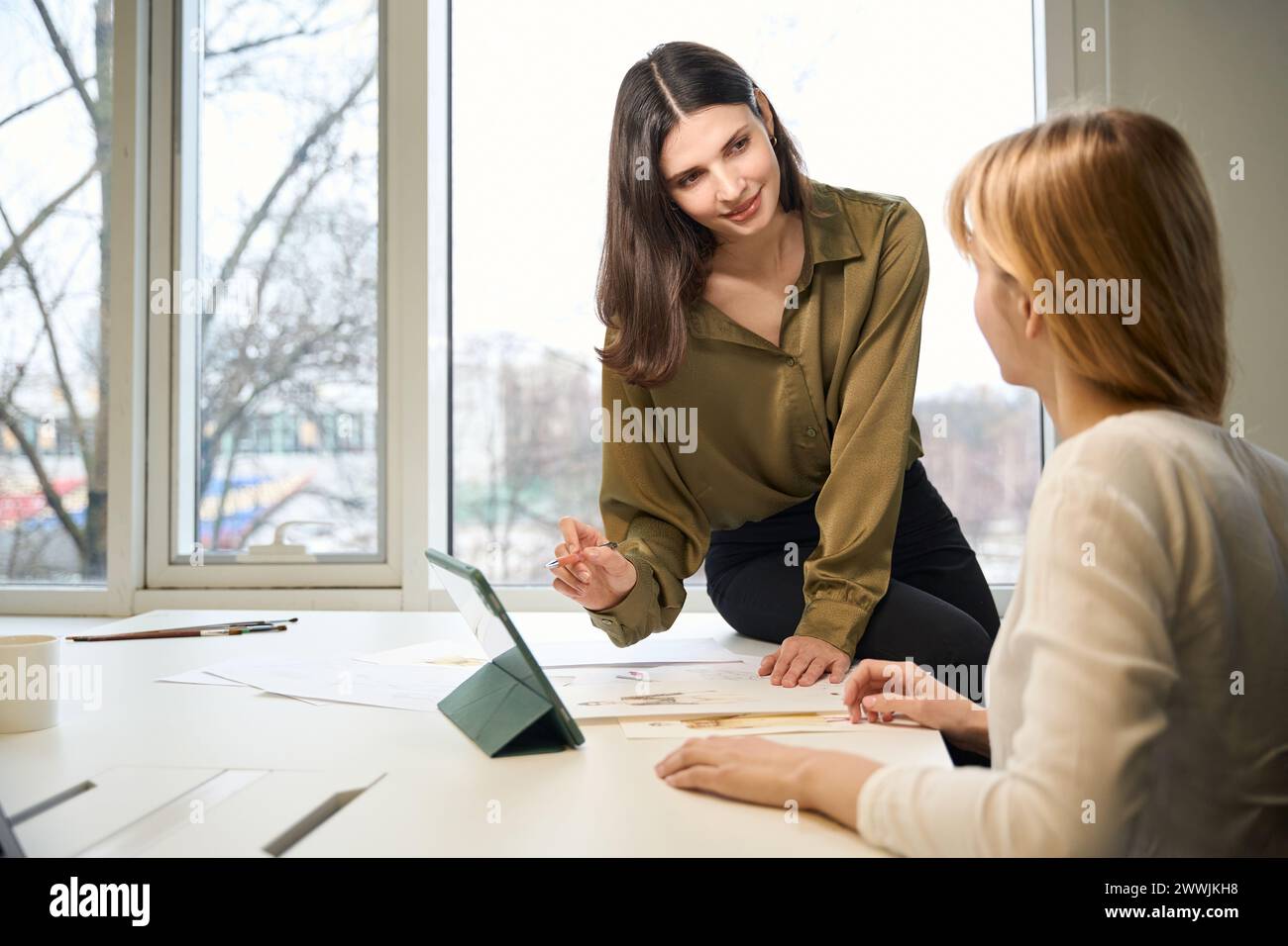 Fashion professionals in coworking environment sharing ideas of ...