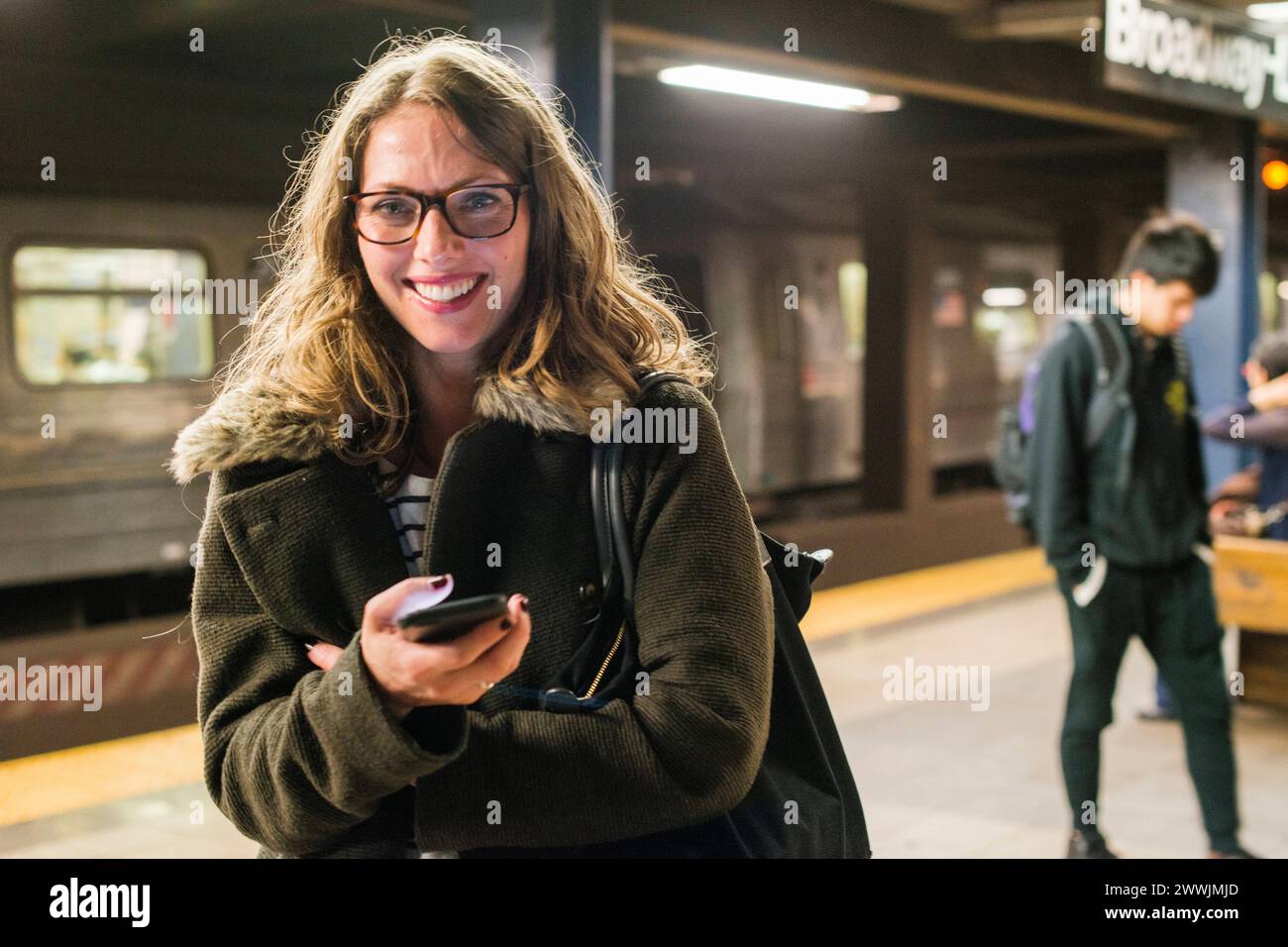 Subway commuter and her smartphone New York City, USA. Blonde, female ...