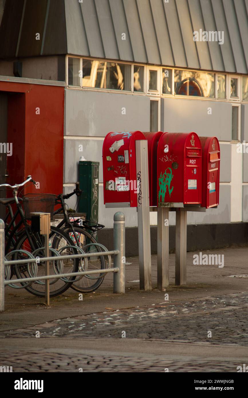 Red mailboxes next to bicycle stand in danish city Stock Photo - Alamy